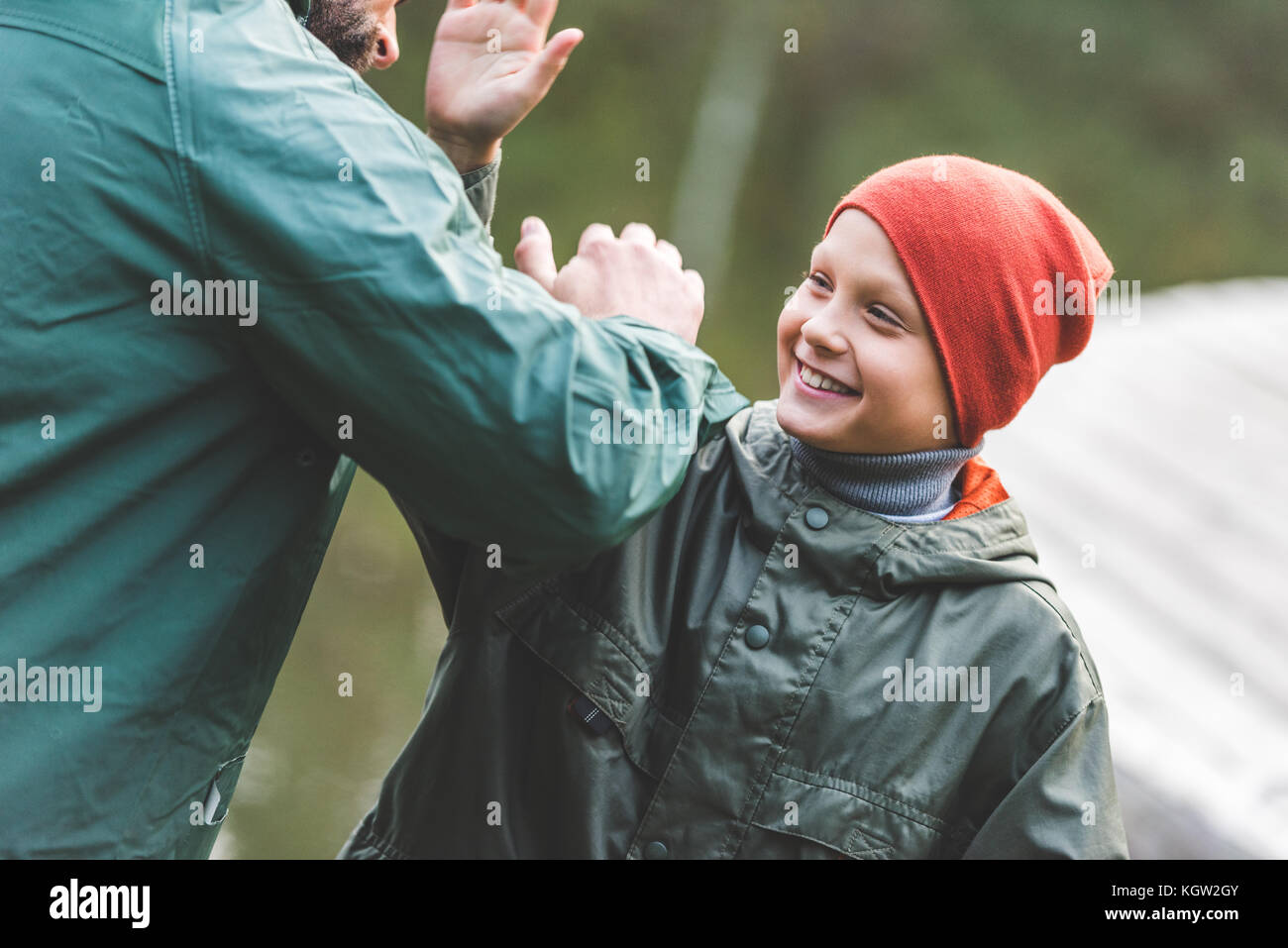 smiling family giving high five Stock Photo - Alamy