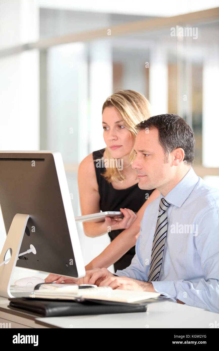 Office workers in front of computer Stock Photo - Alamy