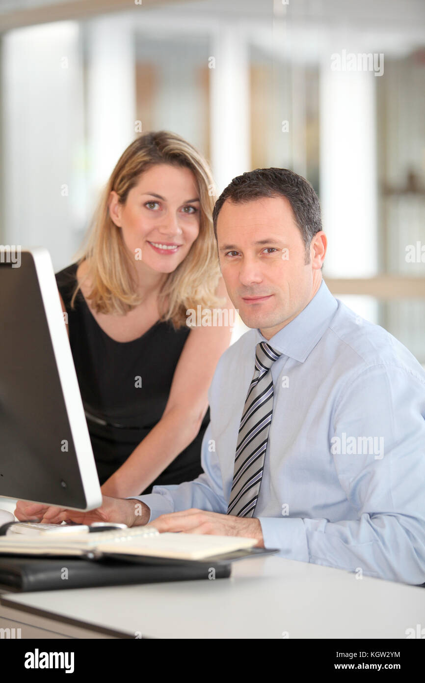 Office workers in front of computer Stock Photo - Alamy