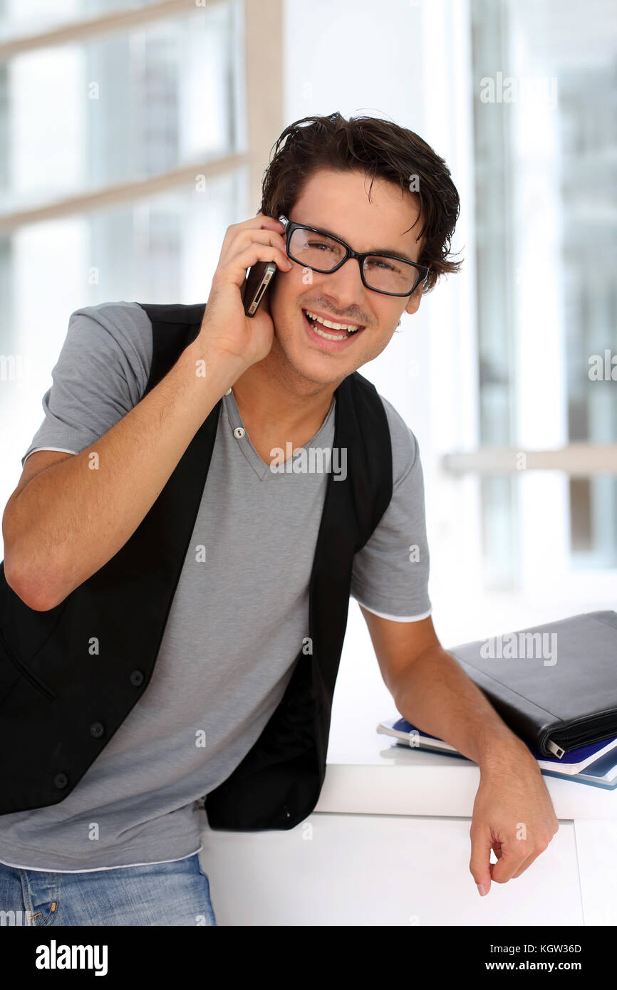 Student in building talking on mobile phone Stock Photo - Alamy