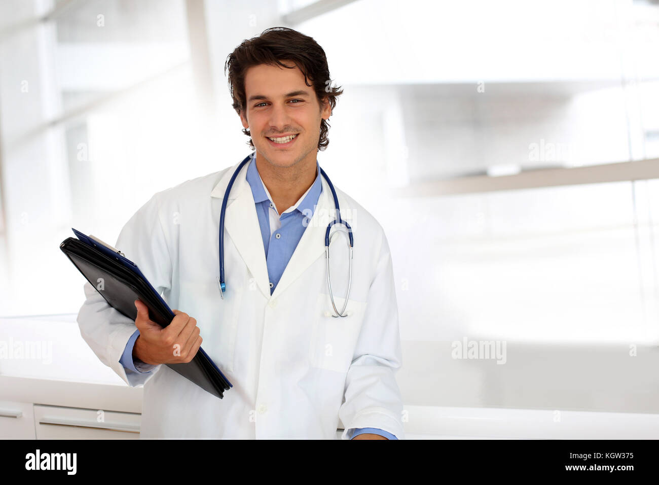 Cheerful student in medicine standing in hospital hallway Stock Photo ...