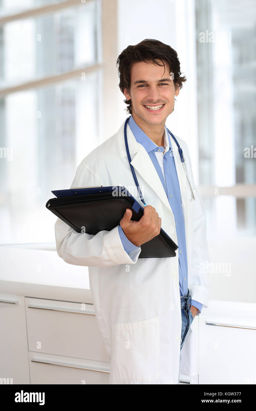 Cheerful student in medicine standing in hospital hallway Stock Photo ...