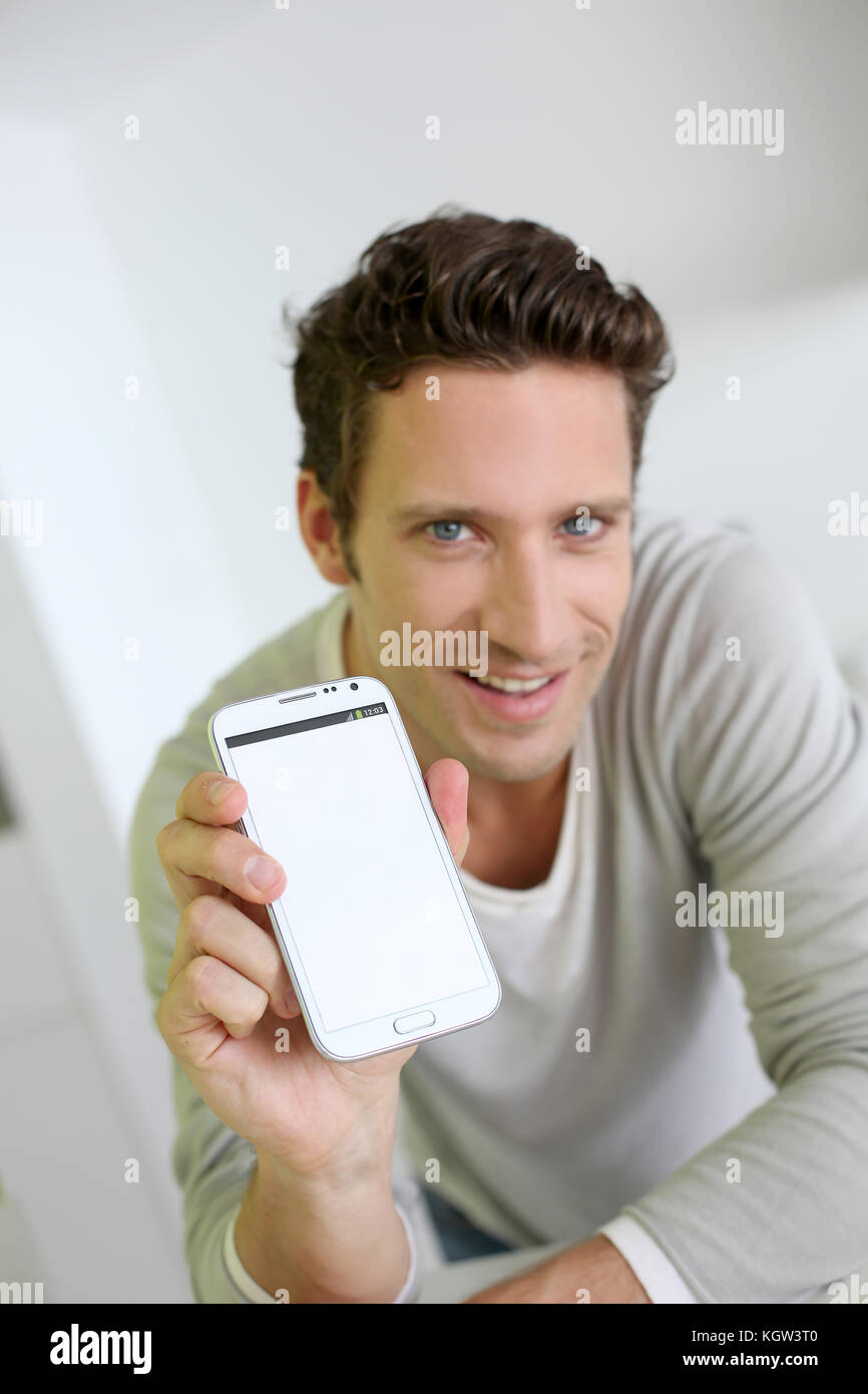 Man showing smartphone to camera Stock Photo - Alamy
