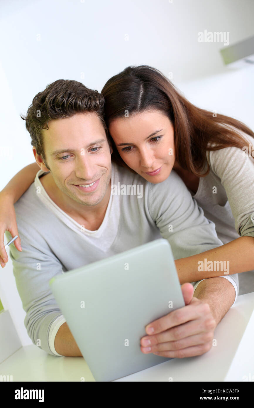 Cheerful couple websurfing on internet with tablet Stock Photo - Alamy