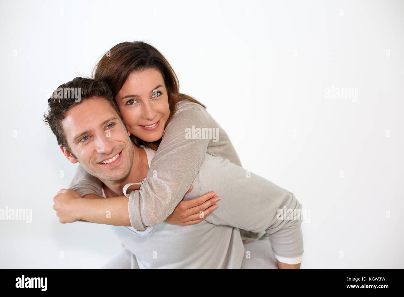 Handsome guy giving piggyback ride to girlfriend Stock Photo - Alamy