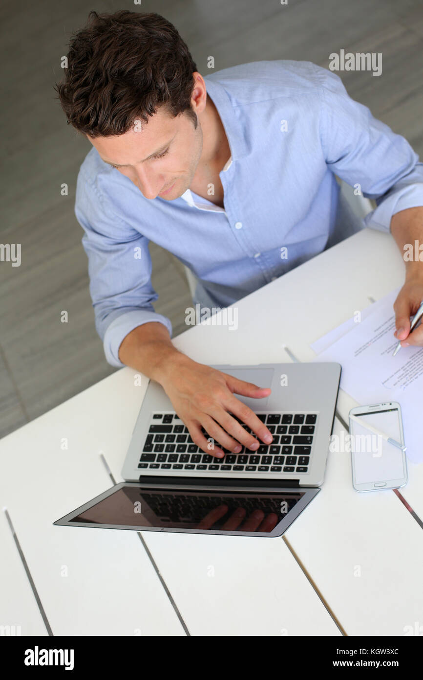 Upper view of smart guy working on laptop at home Stock Photo - Alamy
