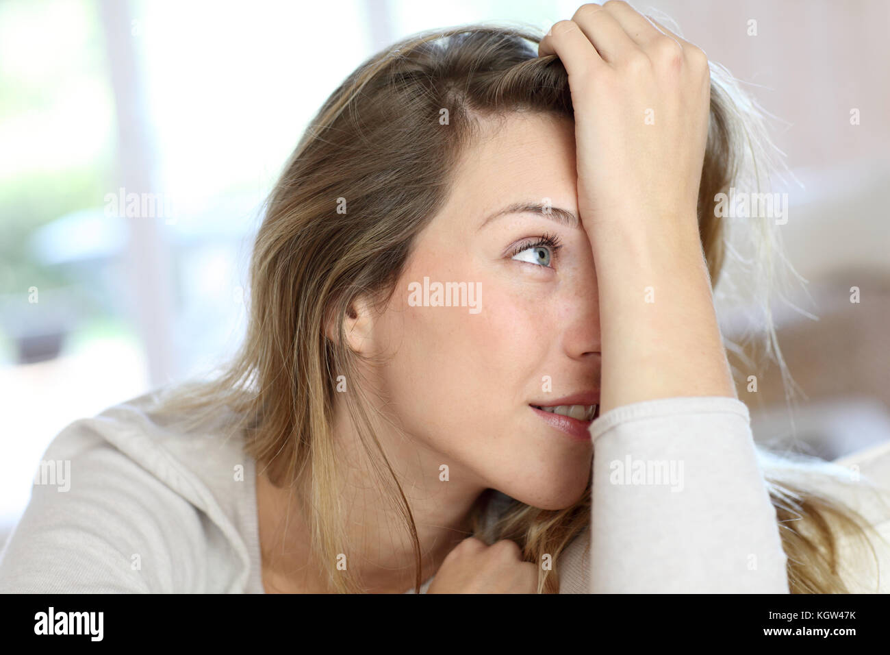 Portrait of blond woman with boring look Stock Photo - Alamy