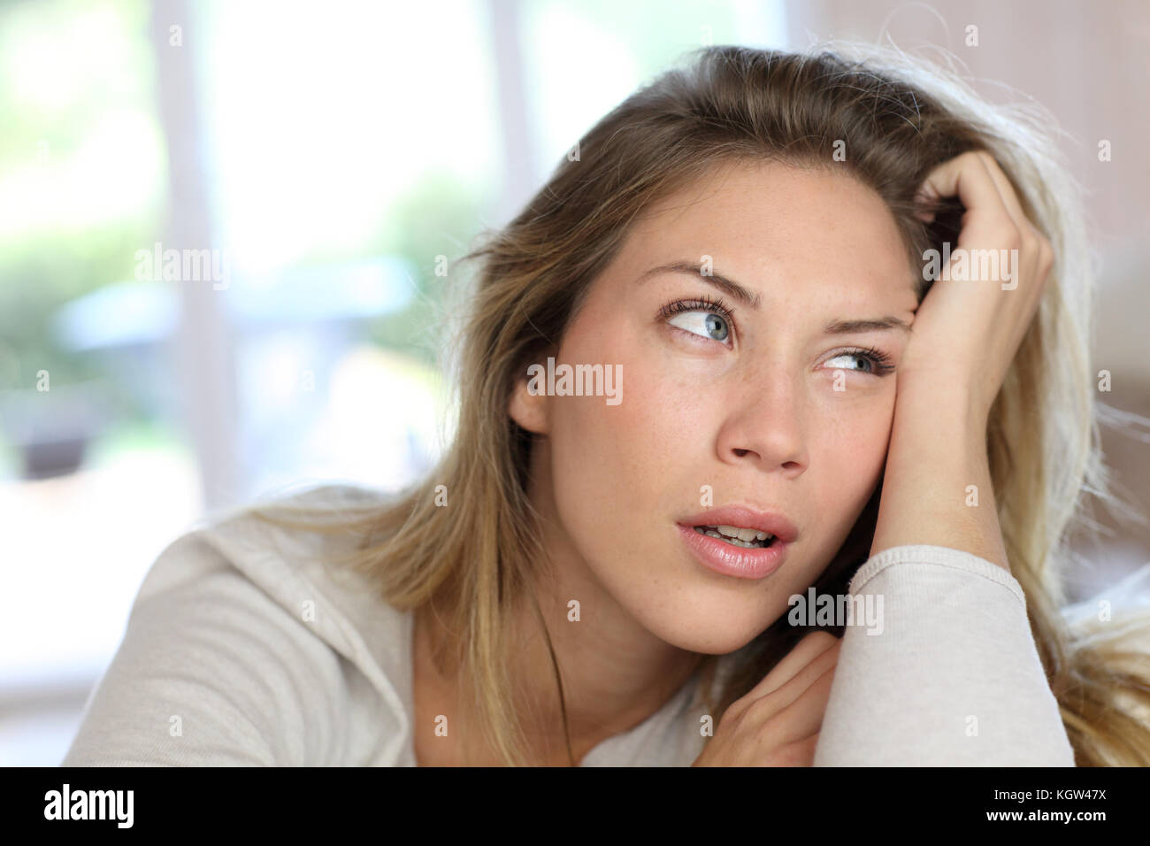Portrait of blond woman with boring look Stock Photo - Alamy