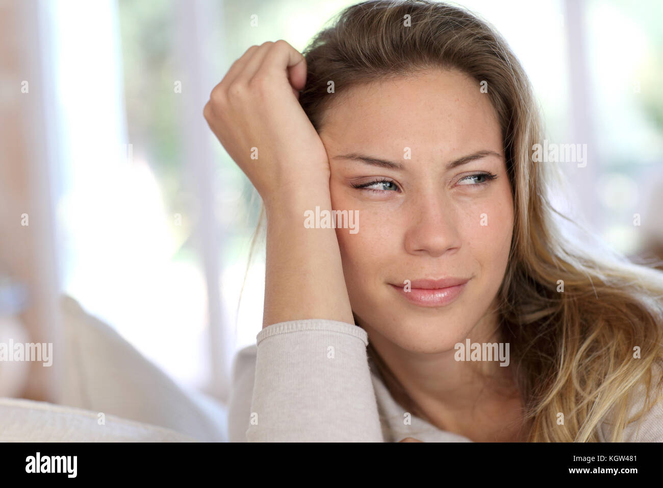 Portrait of young girl looking on one side Stock Photo - Alamy