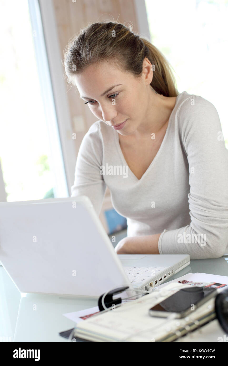 Woman working at home on laptop computer Stock Photo - Alamy