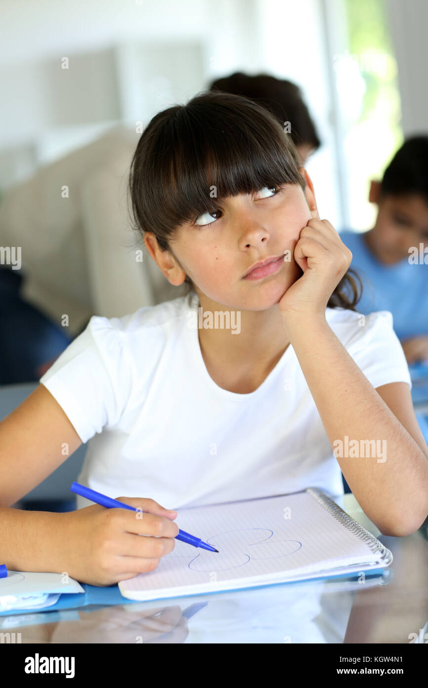 Young school girl with bored look on her face Stock Photo - Alamy