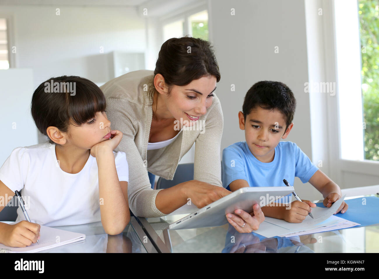 Woman teaching class to school children with digital tablet Stock Photo ...