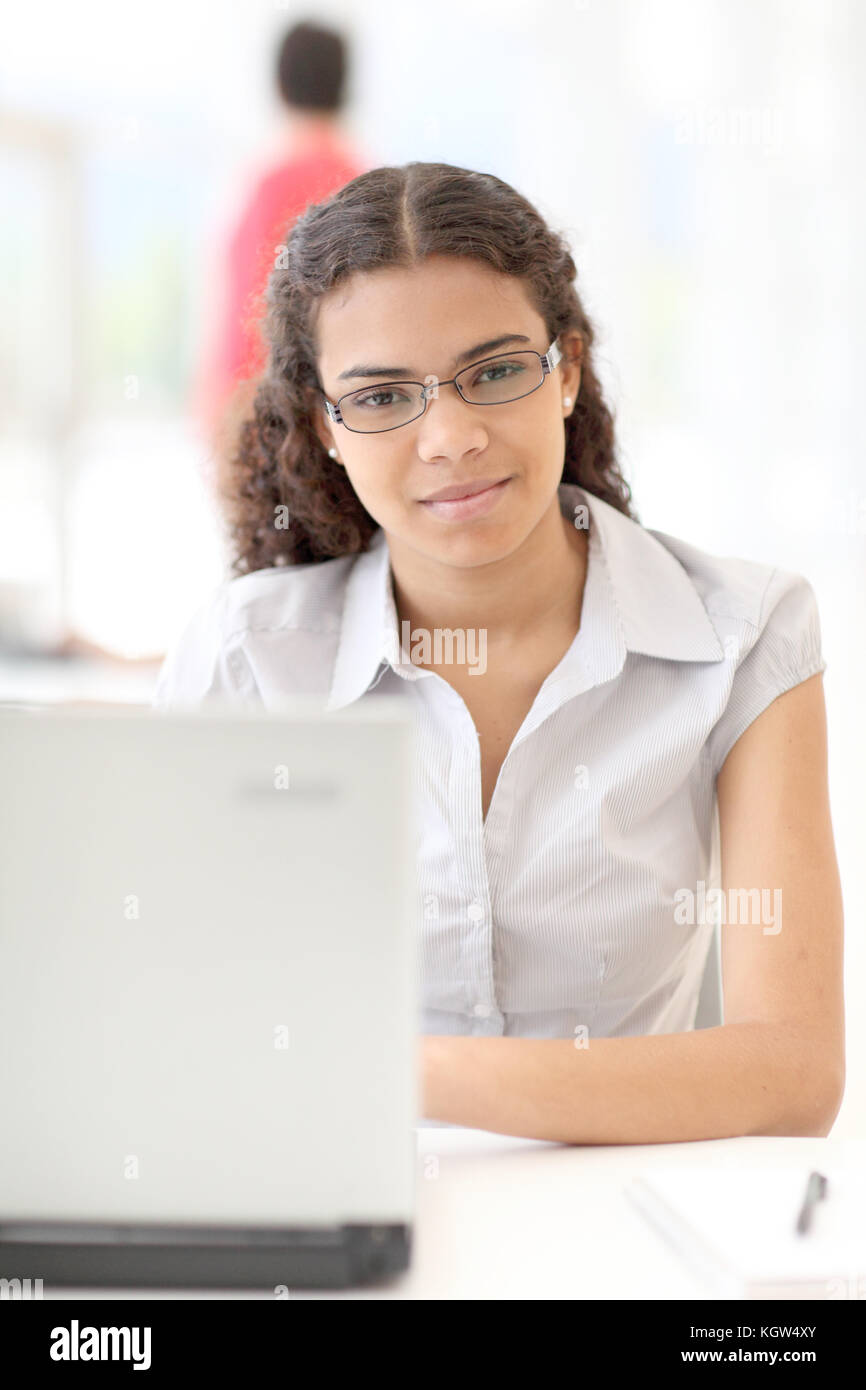 Portrait of smiling student in front of laptop computer Stock Photo - Alamy