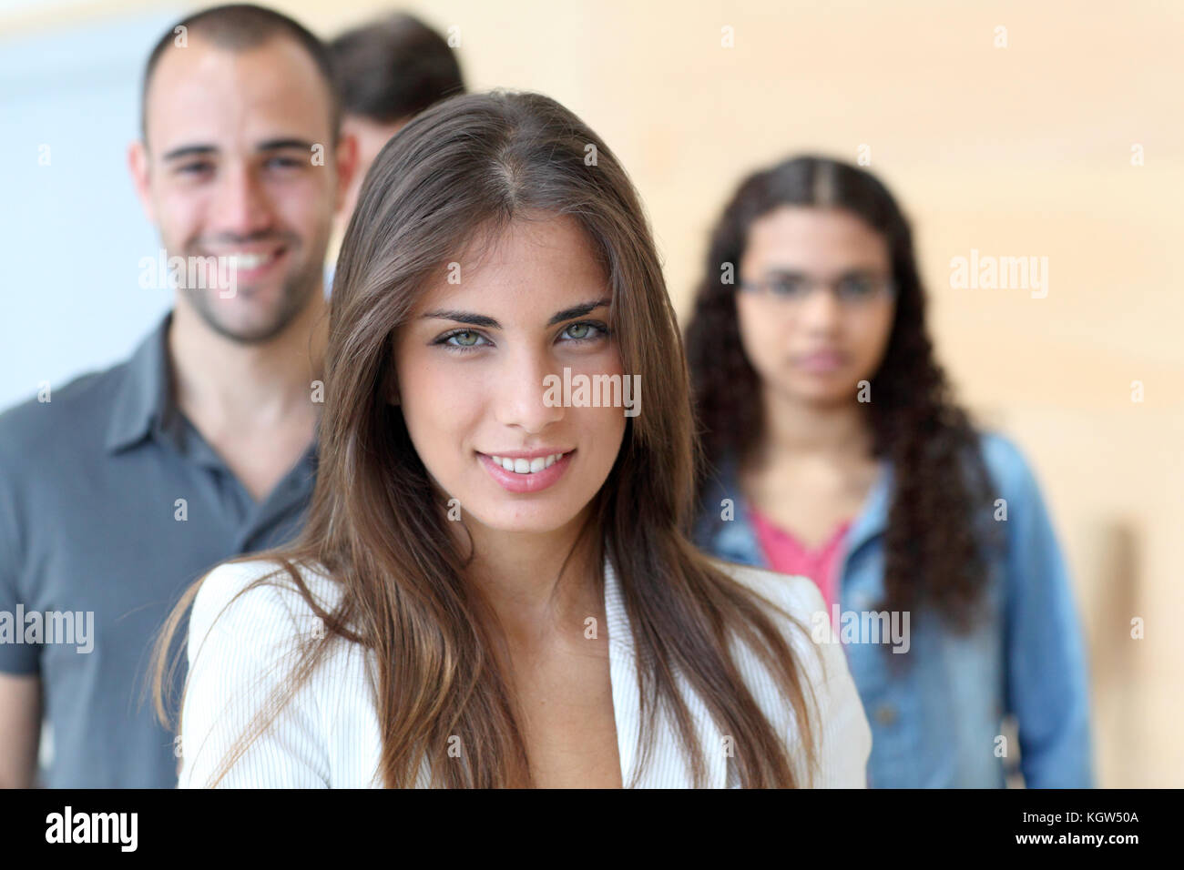 Portrait of student standing in front of group Stock Photo - Alamy