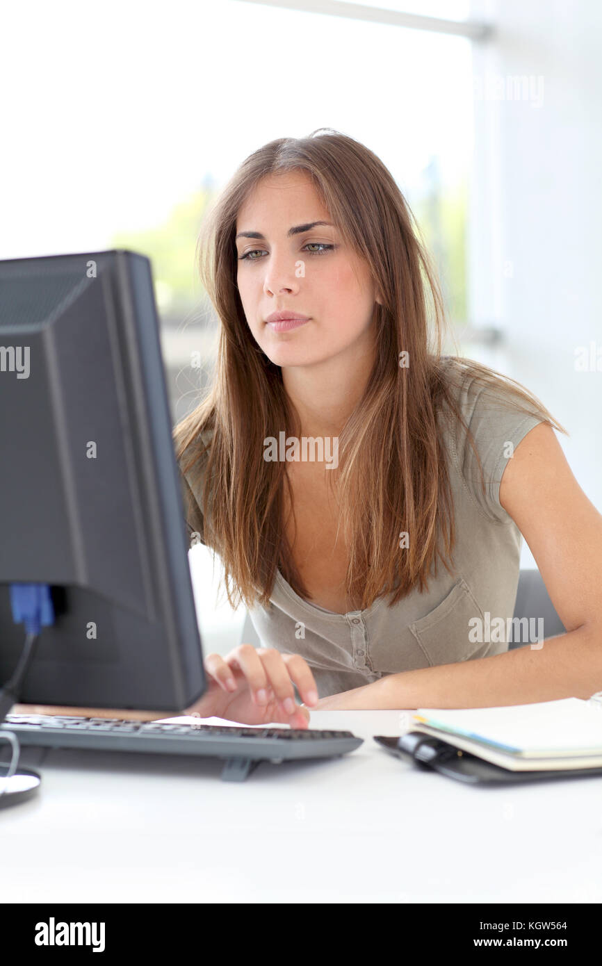 Young woman working on desktop computer Stock Photo - Alamy