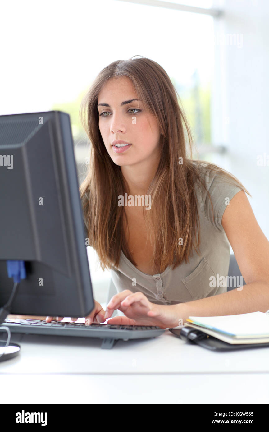 Young woman working on desktop computer Stock Photo - Alamy