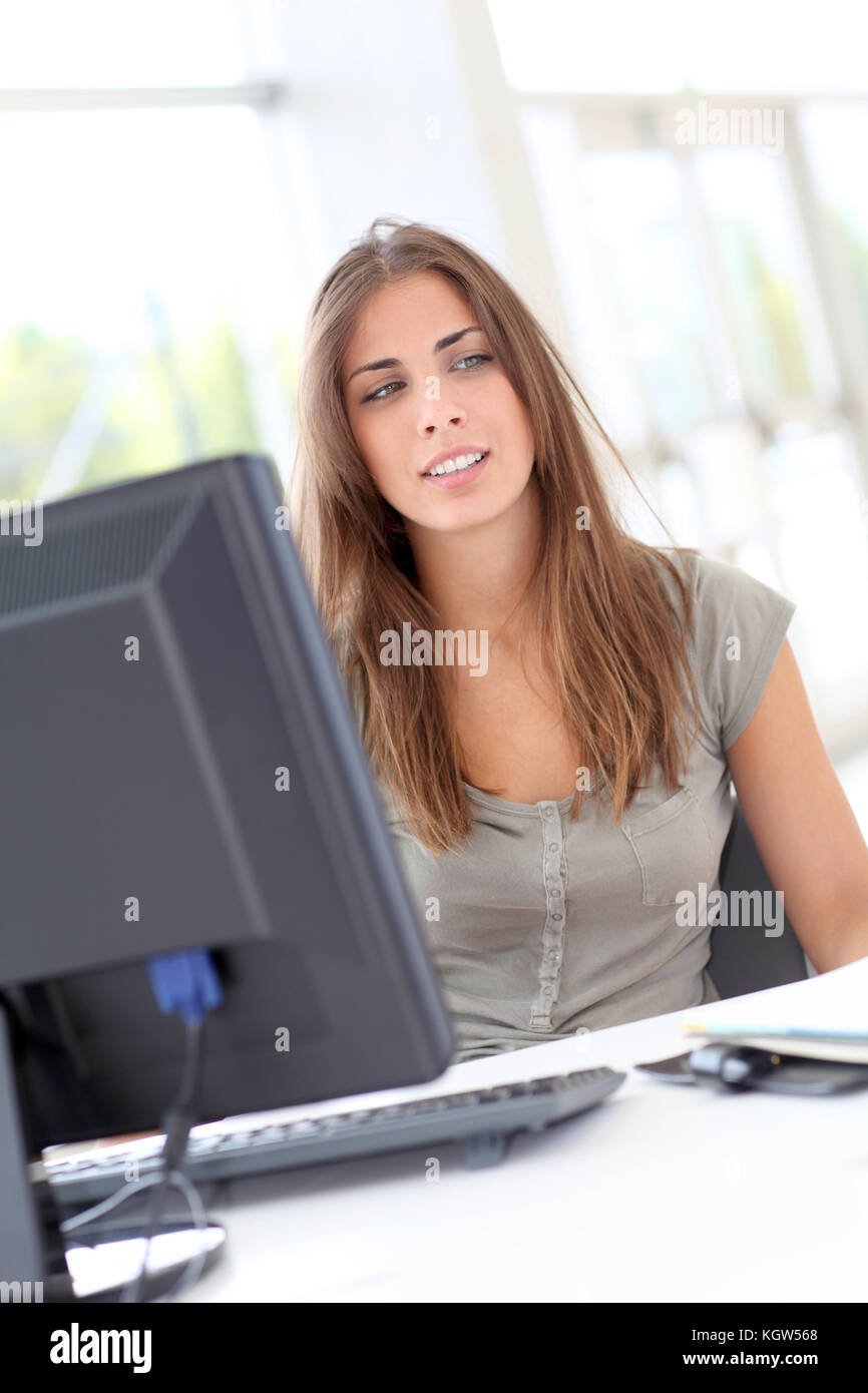 Young woman working on desktop computer Stock Photo - Alamy