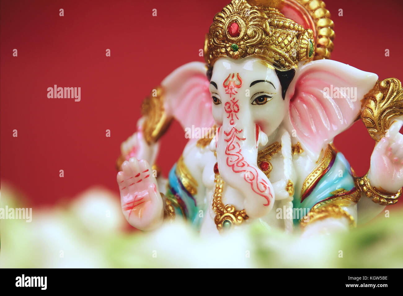 Hindu God Ganesha with jasmine flower Stock Photo - Alamy