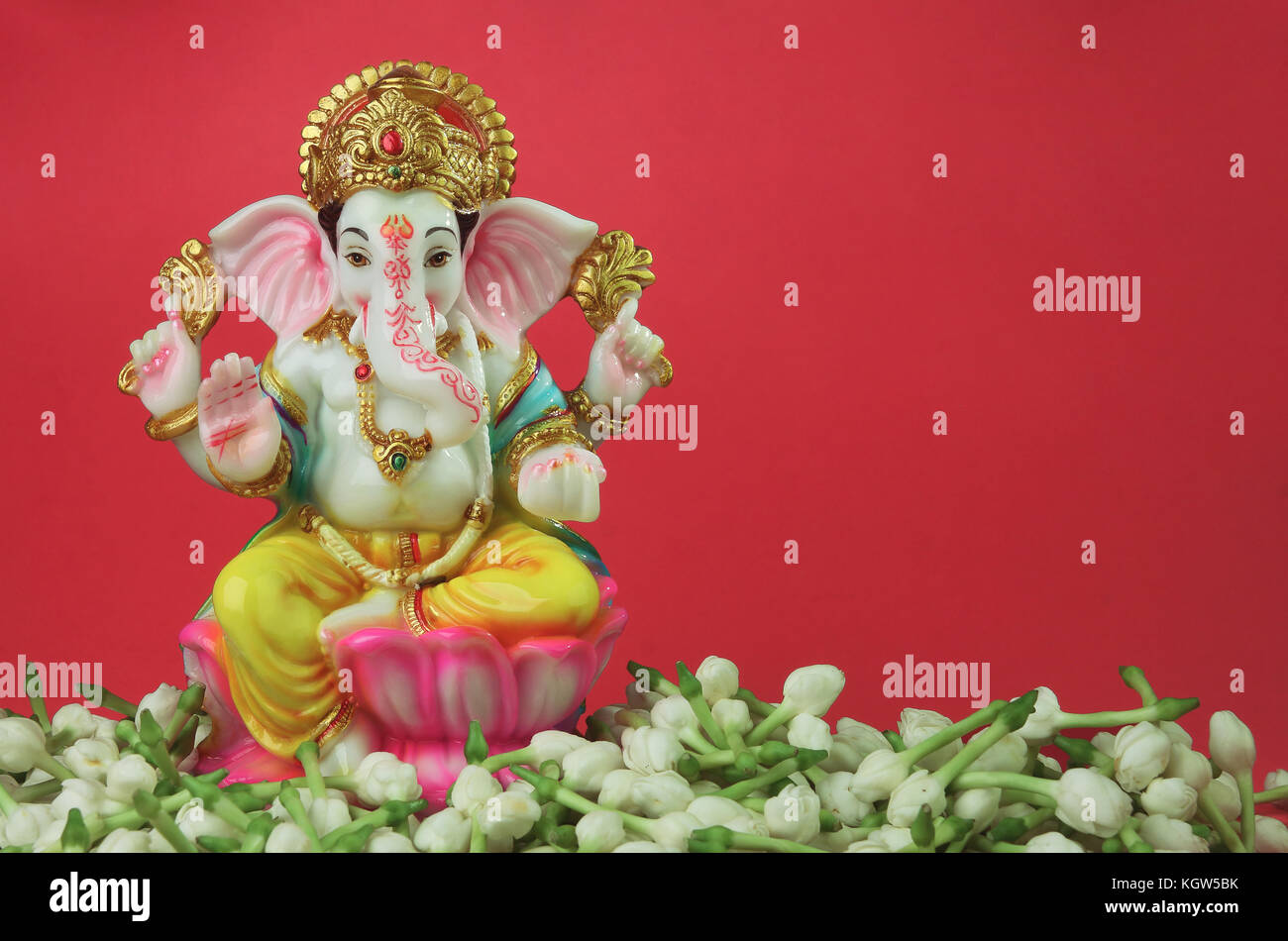 Hindu God Ganesha with jasmine flower Stock Photo - Alamy