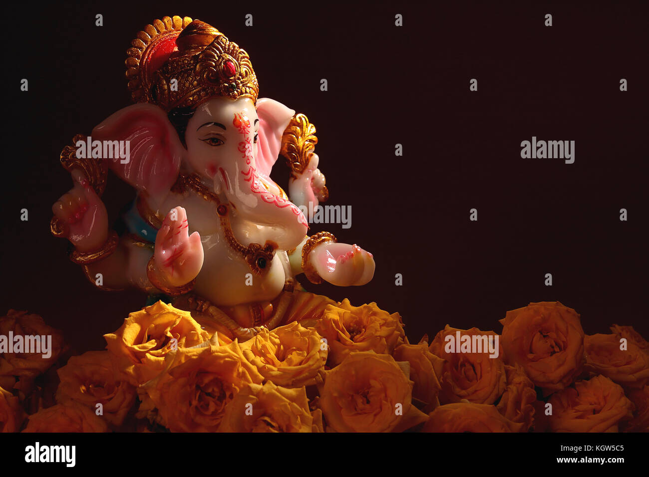 Hindu God Ganesha with Rose Flowers Stock Photo - Alamy