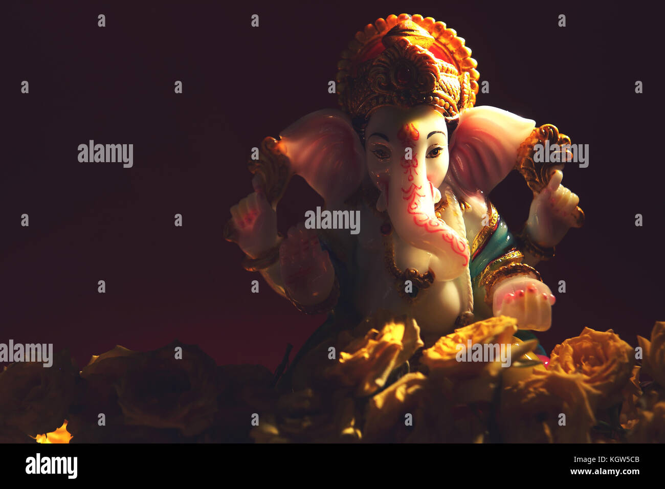 Hindu God Ganesha with Rose Flowers Stock Photo - Alamy