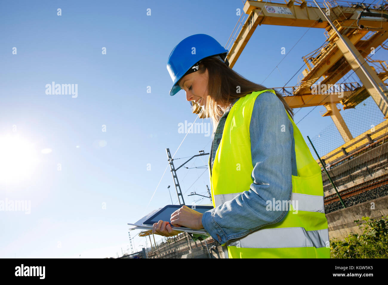 Site manager using electronic tablet Stock Photo - Alamy