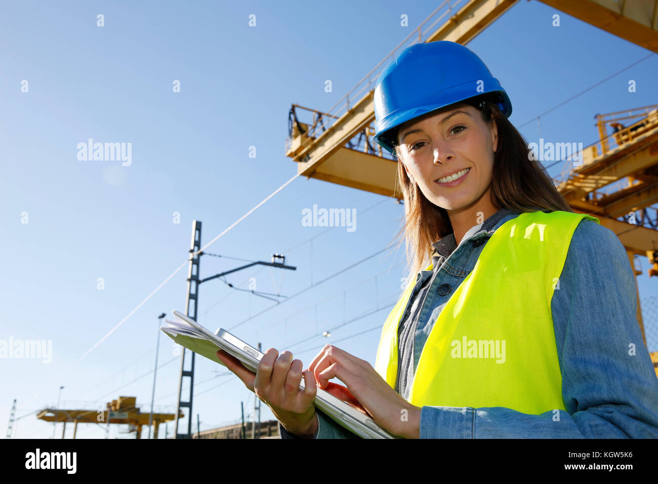 Site manager using electronic tablet Stock Photo - Alamy