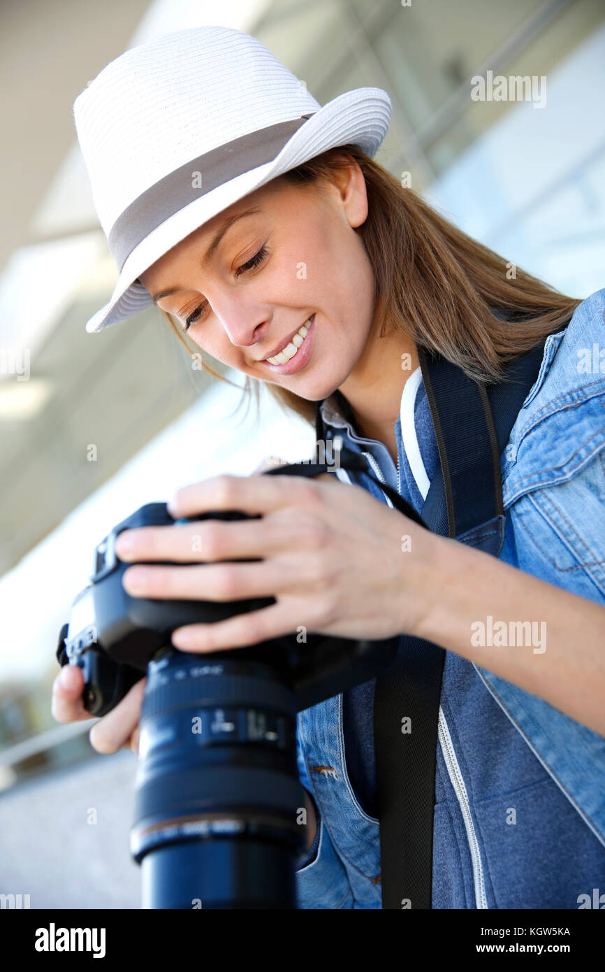 Young reporter looking at photo captures Stock Photo - Alamy