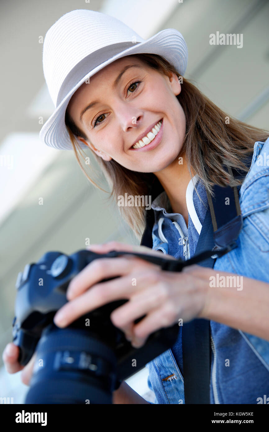 Young reporter looking at photo captures Stock Photo - Alamy