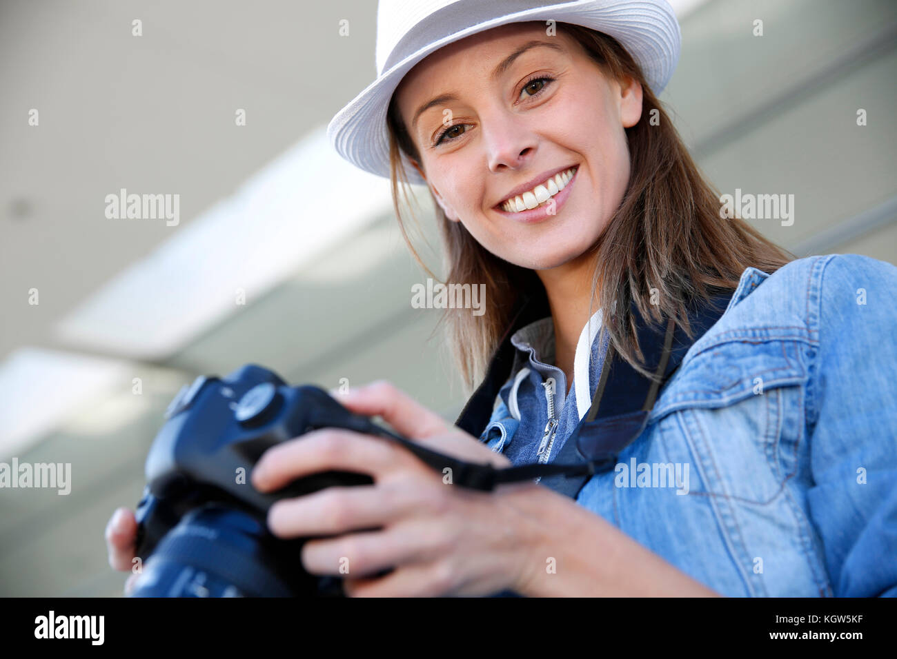 Young reporter looking at photo captures Stock Photo - Alamy