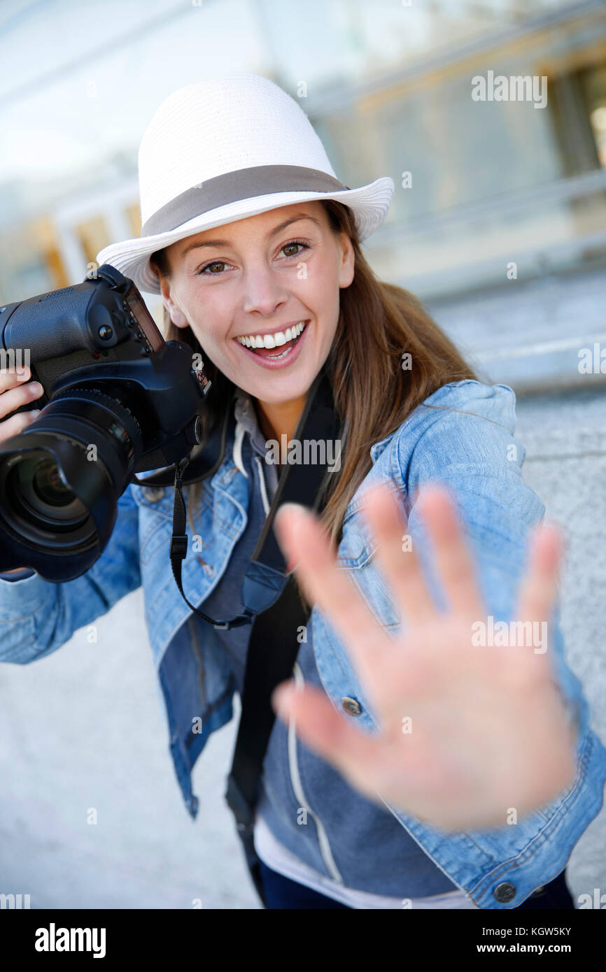 Cheerful photographer showing hand towards camera Stock Photo - Alamy