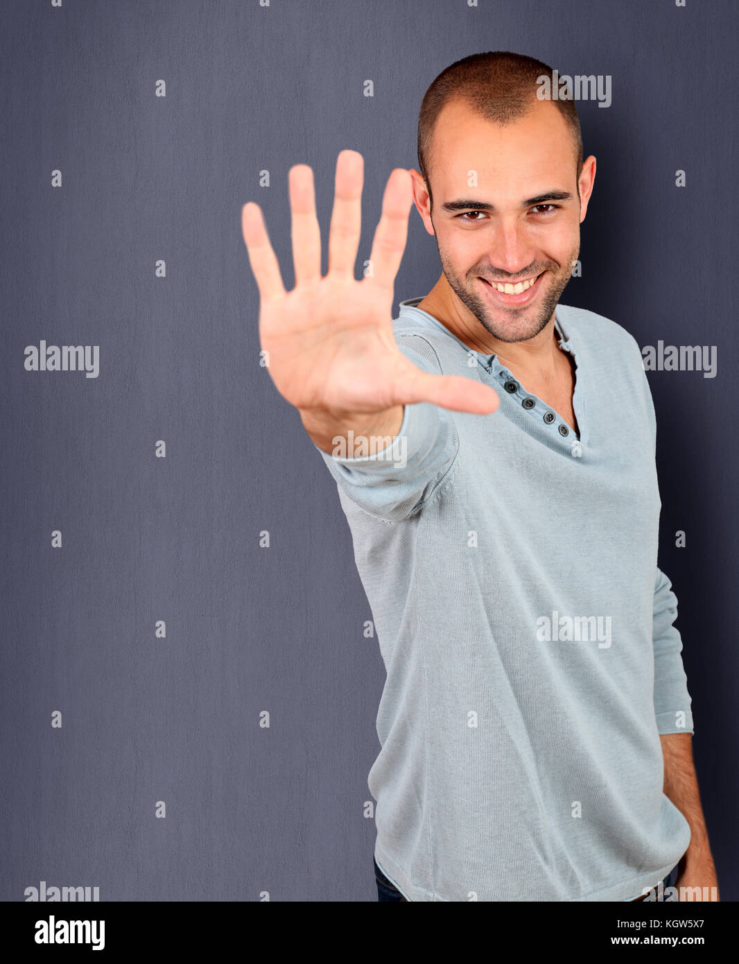 Handsome man showing hand to camera Stock Photo - Alamy