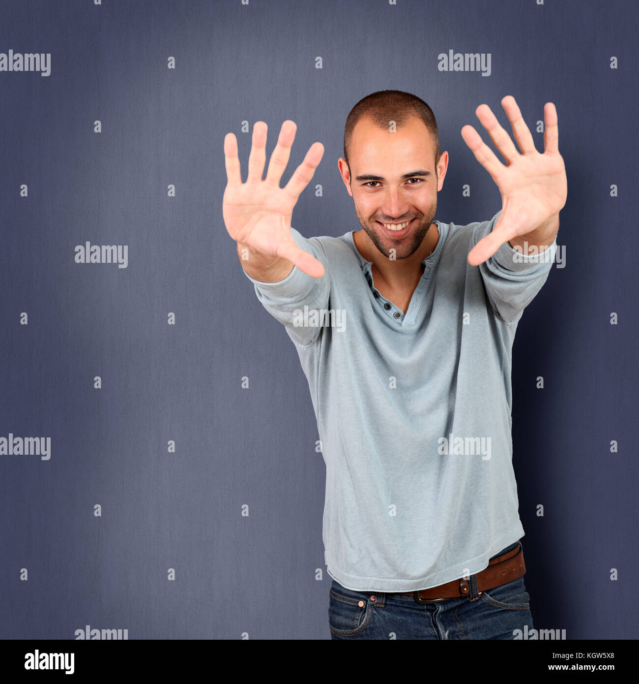 Handsome man showing hands up Stock Photo - Alamy