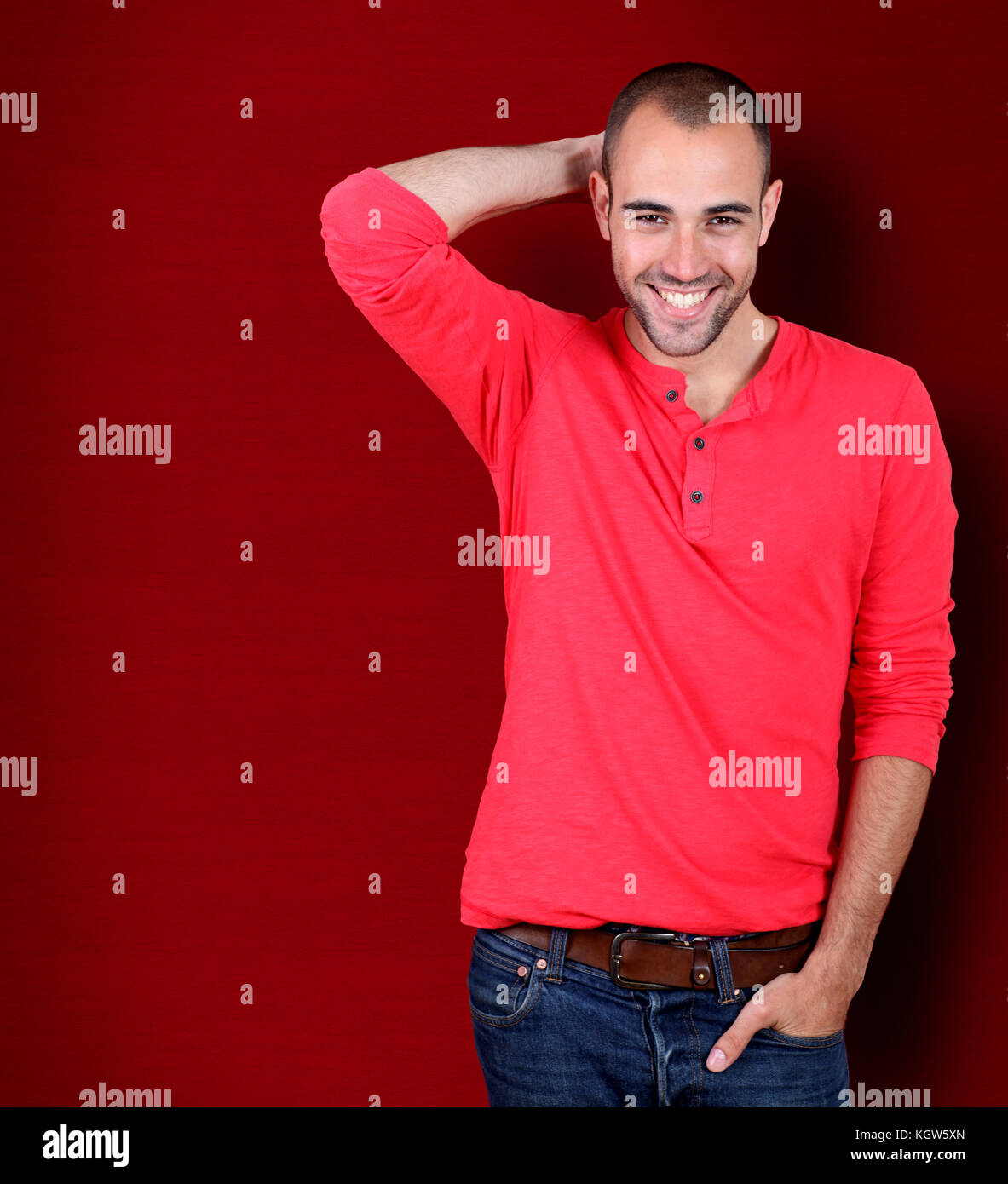 Handsome man standing on red background Stock Photo - Alamy
