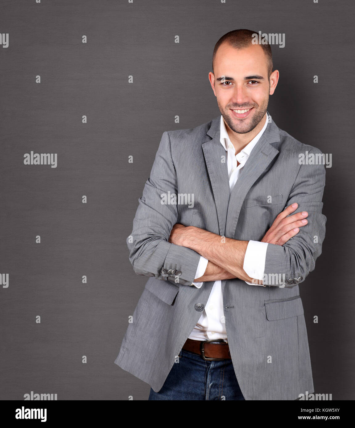 Cool businessman standing on grey background Stock Photo - Alamy