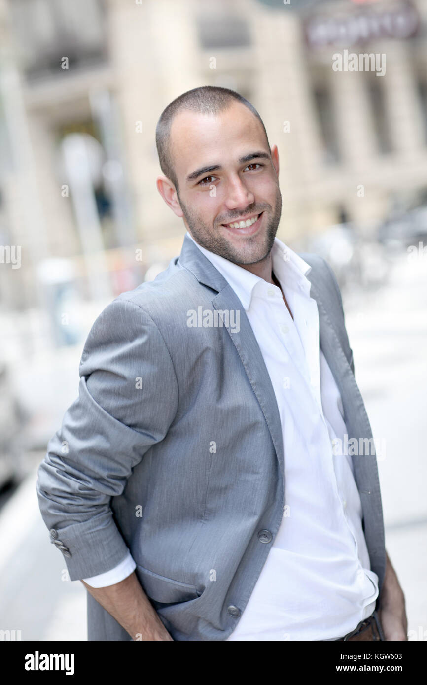 Cheerful young man walking in town Stock Photo - Alamy
