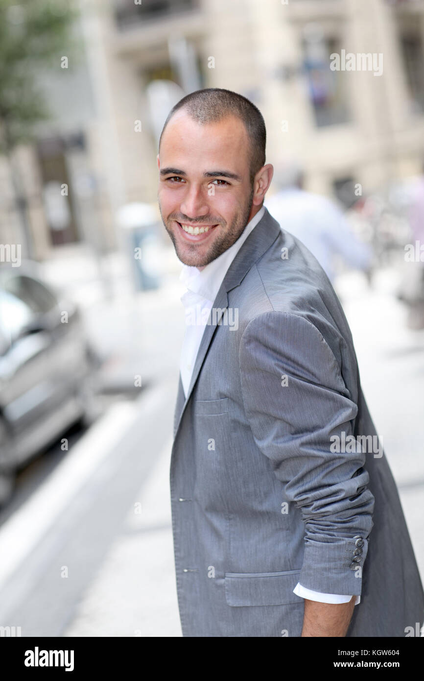 Cheerful young man walking in town Stock Photo - Alamy