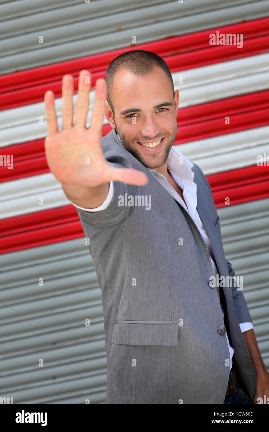 Attractive man showing hand to camera Stock Photo - Alamy