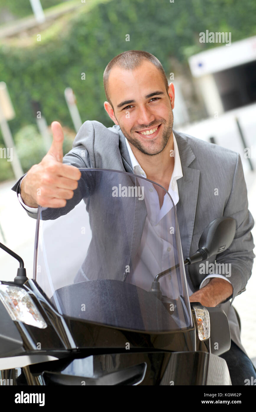 Man going to work on motorcycle Stock Photo - Alamy