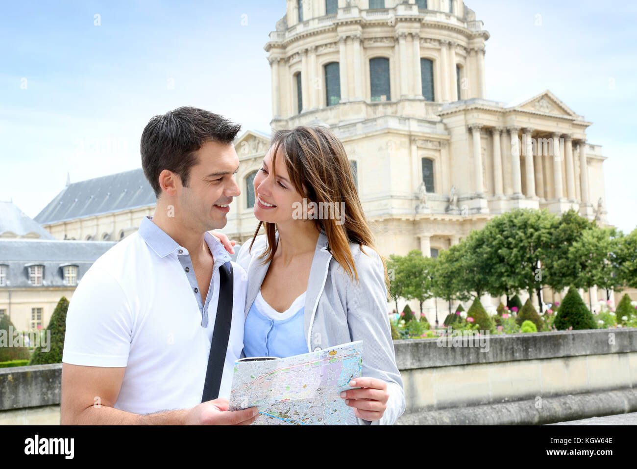 Couple reading tourist map in front of the Invalides building Stock ...