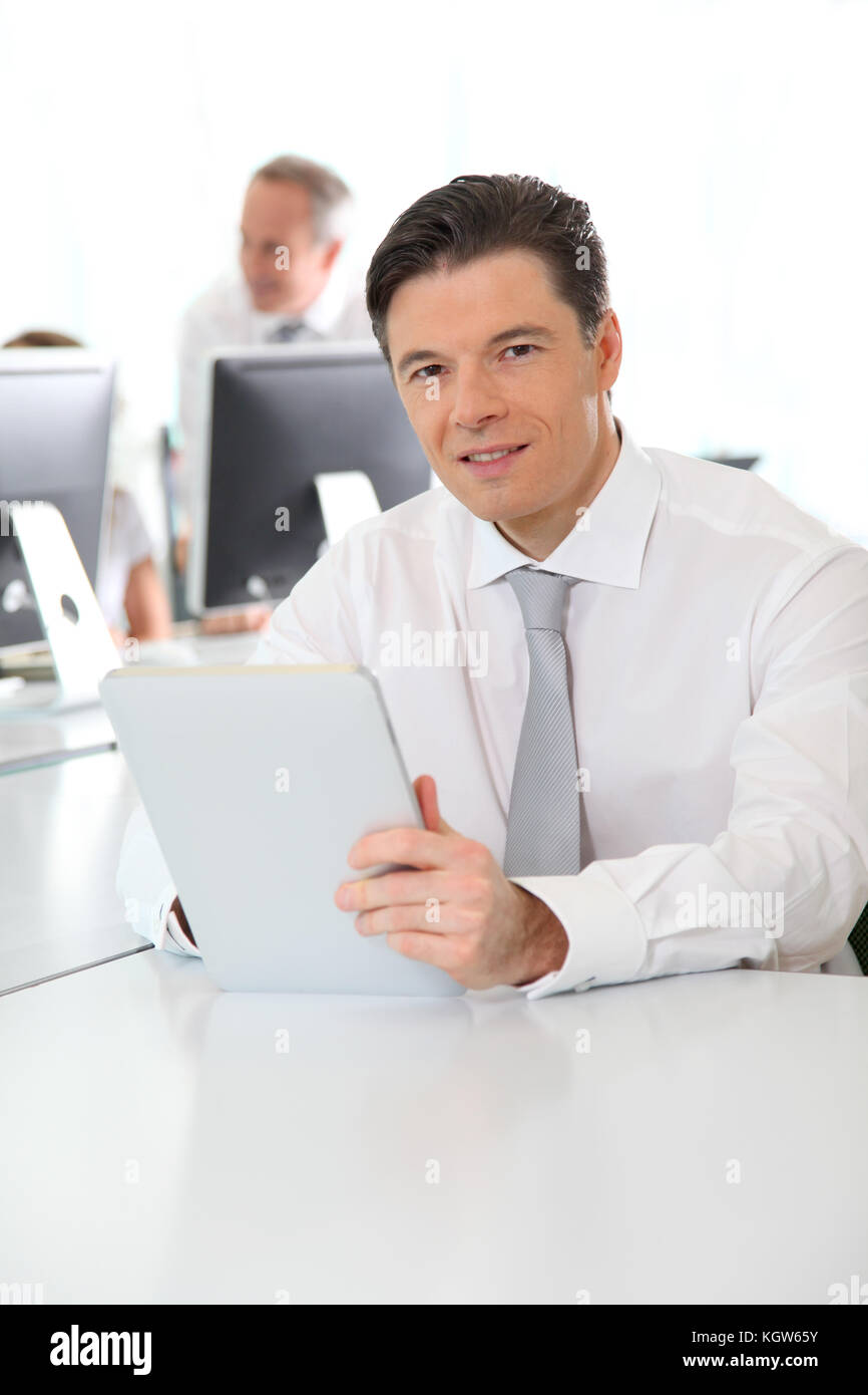 Office worker using electronic tablet in office Stock Photo - Alamy