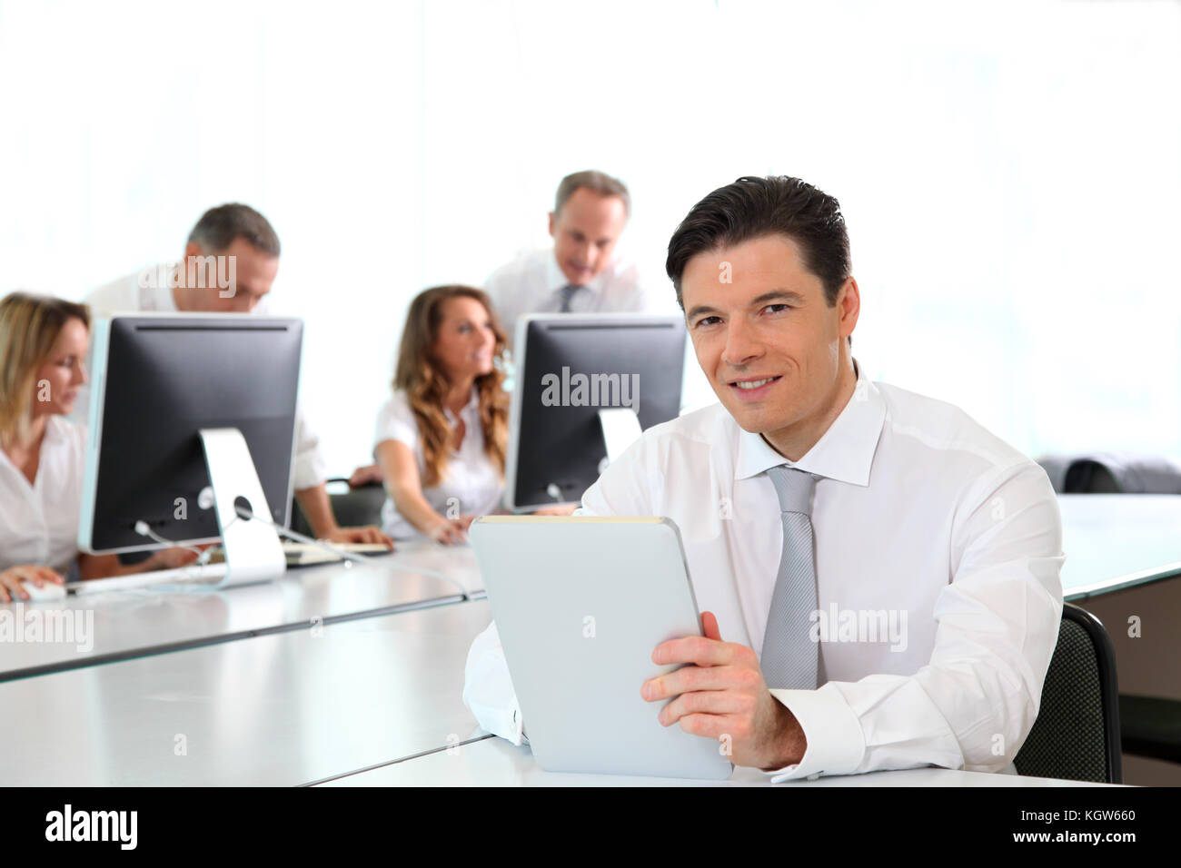 Office worker using electronic tablet in office Stock Photo - Alamy