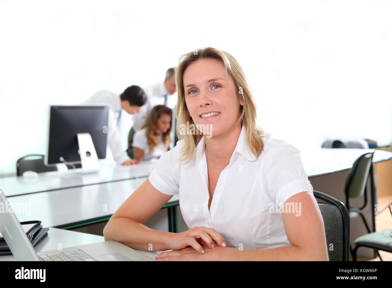 Portrait of smiling office worker Stock Photo - Alamy