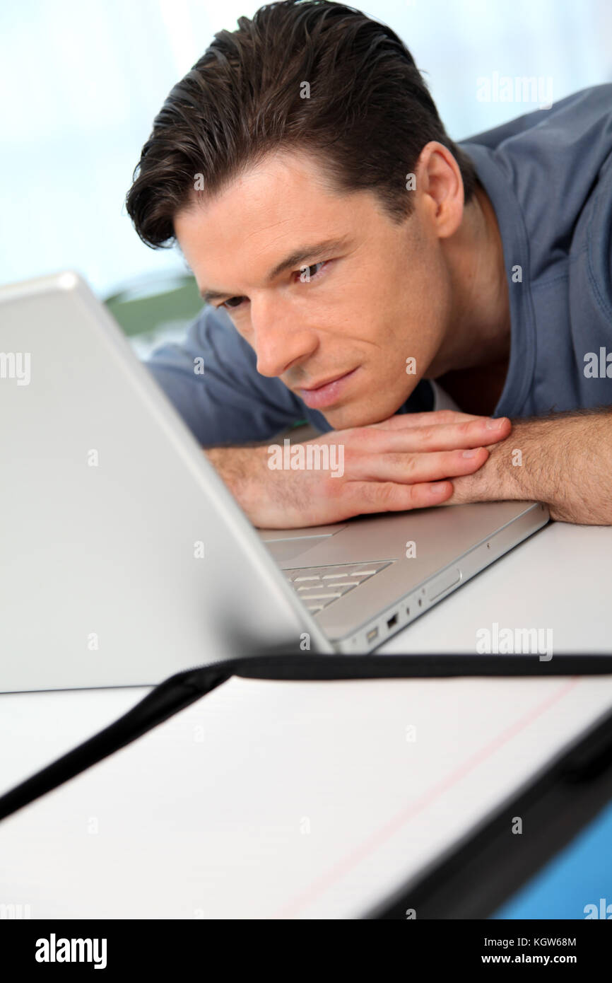 Office worker with exhausted look in front of computer Stock Photo - Alamy