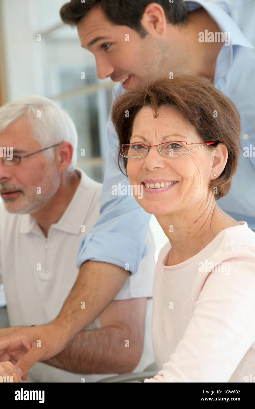 Portrait of senior woman attending computing training Stock Photo - Alamy