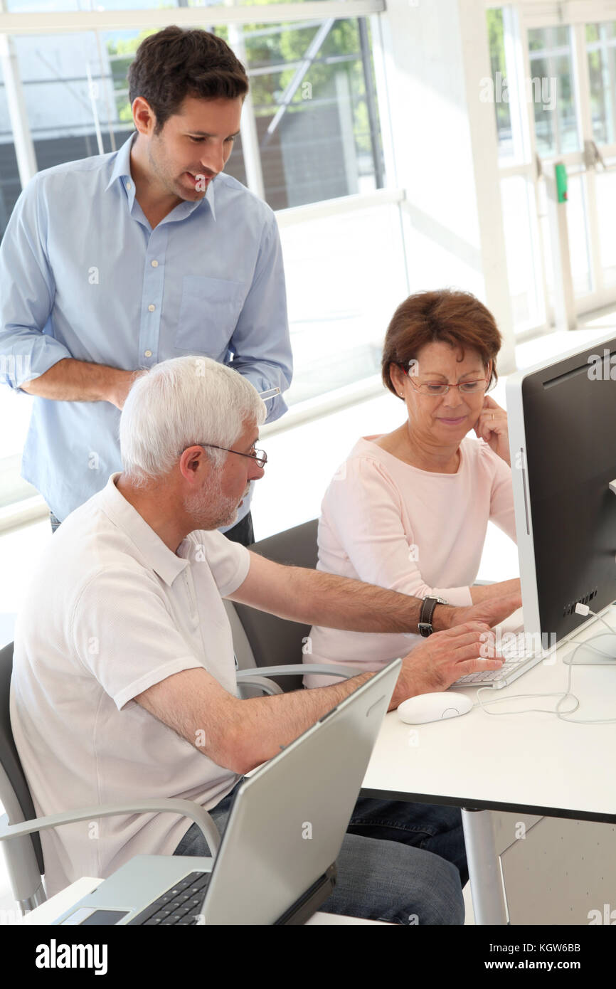 Senior people attending business training Stock Photo - Alamy