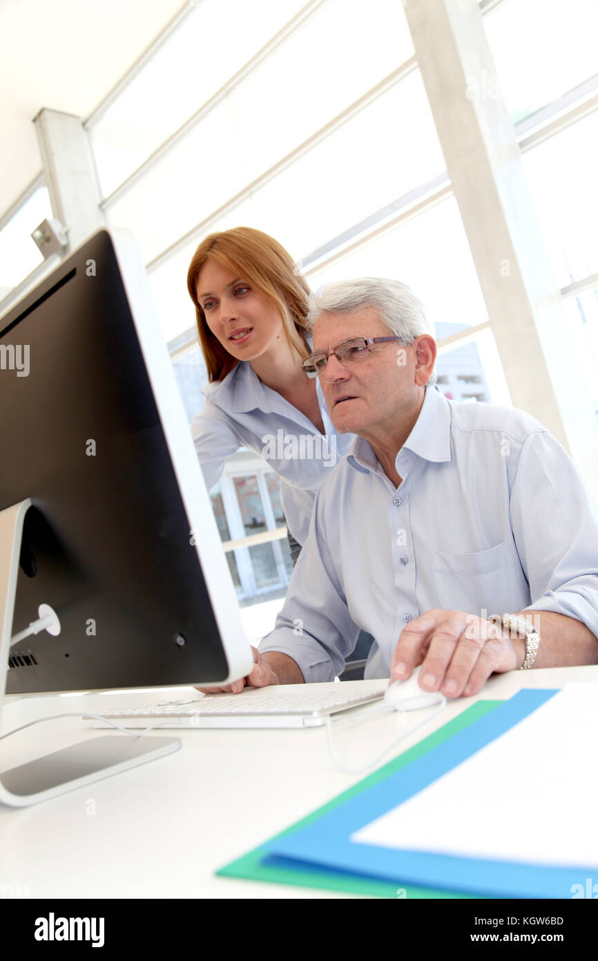Senior man in front of desktop computer Stock Photo - Alamy