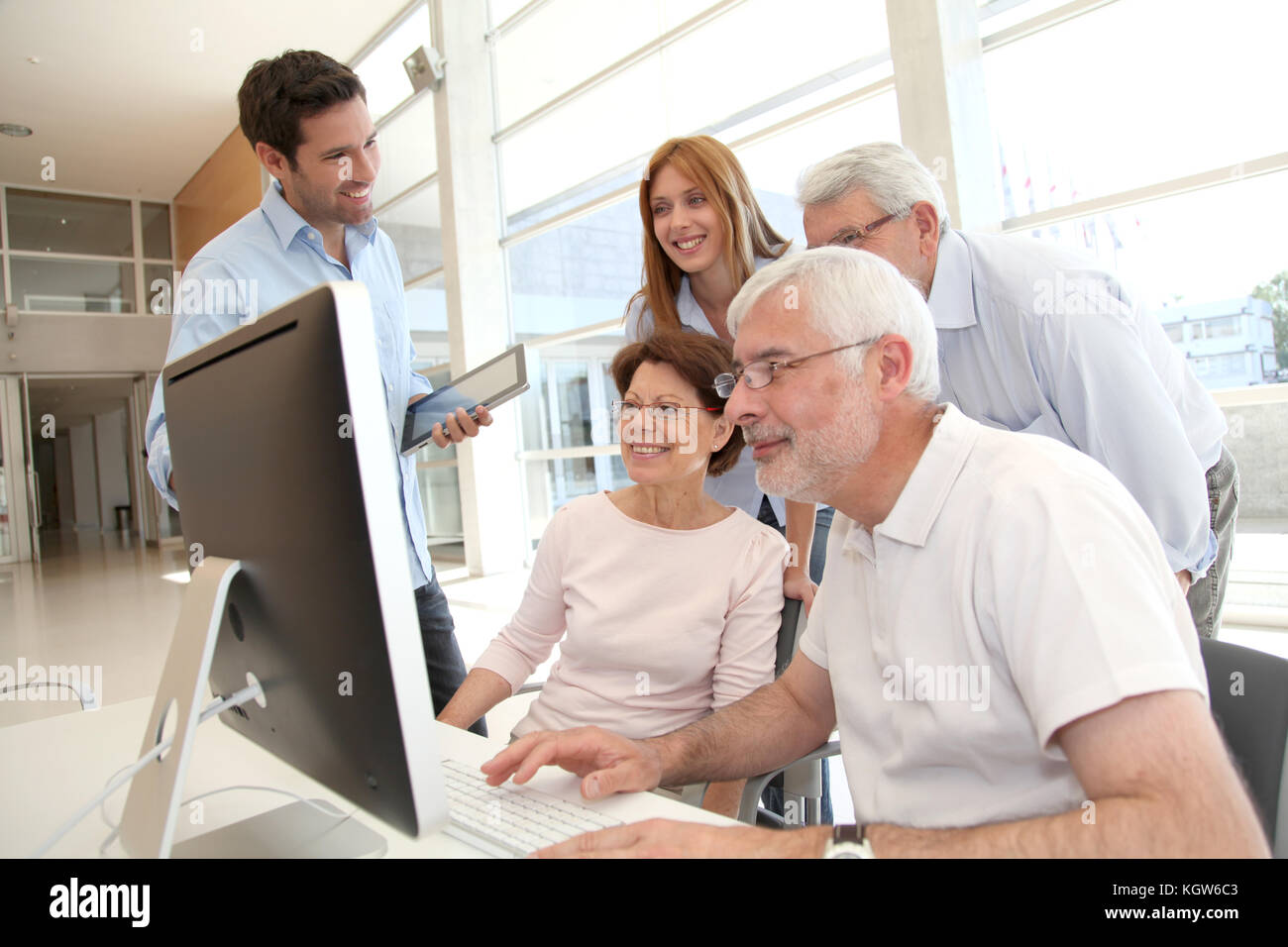 Senior people attending business training Stock Photo - Alamy