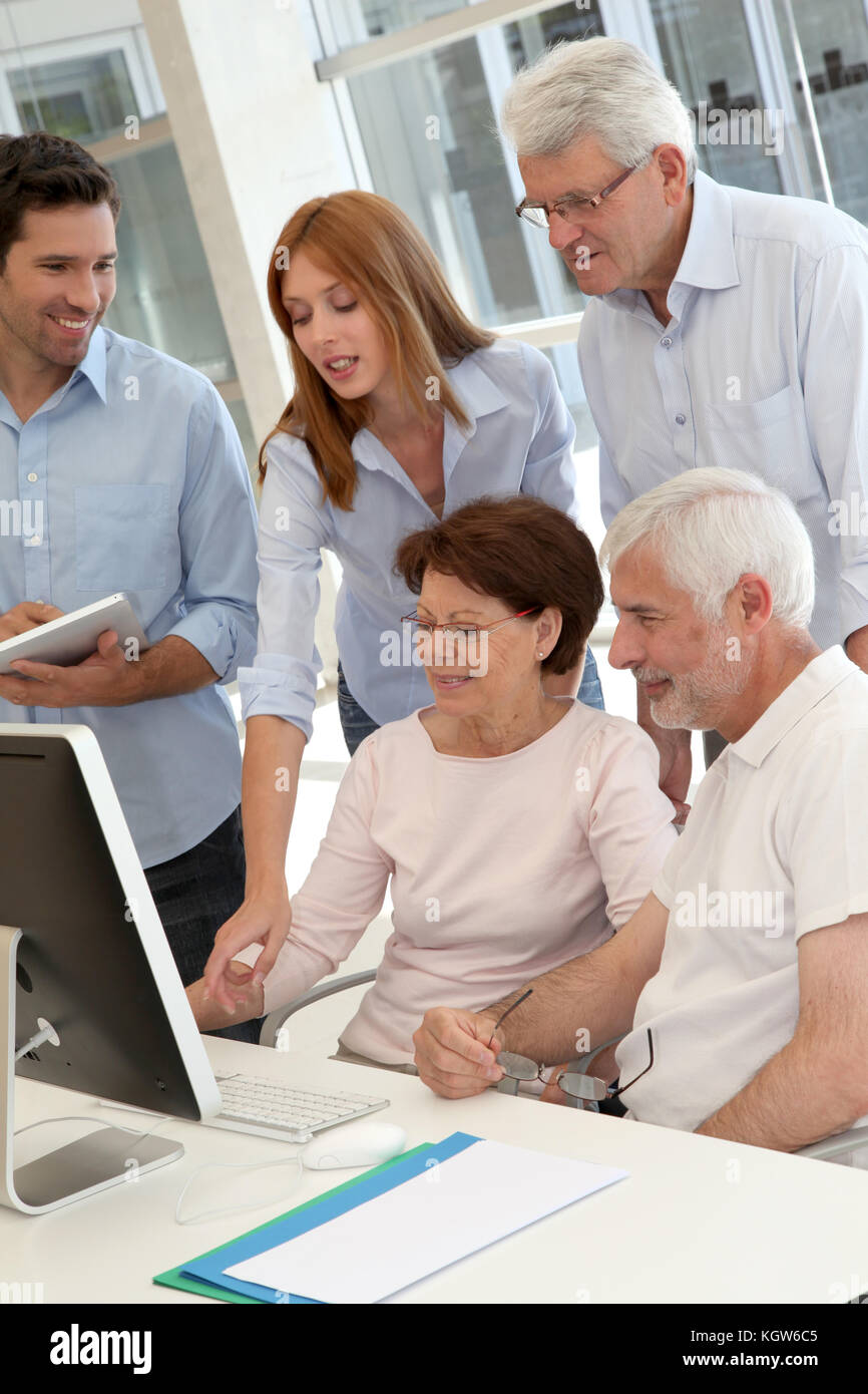 Senior people attending business training Stock Photo - Alamy