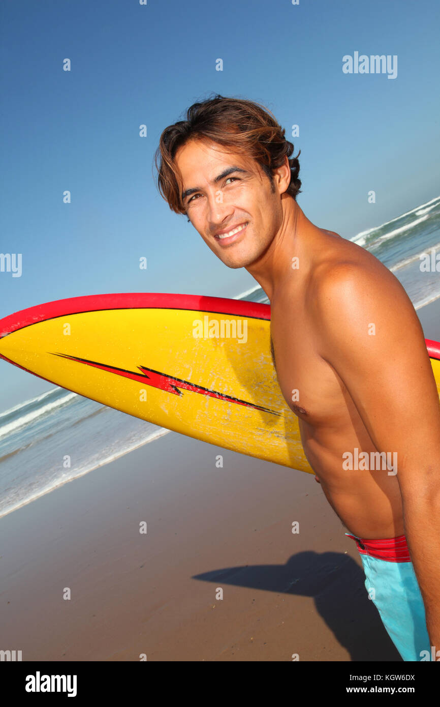 Portrait of handsome surfer at the beach Stock Photo - Alamy